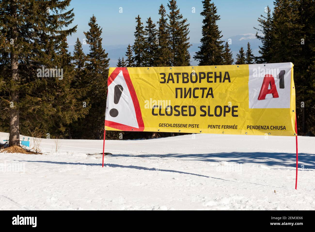 Closed slope yellow multilingual warning banner or sign for a ski piste ...