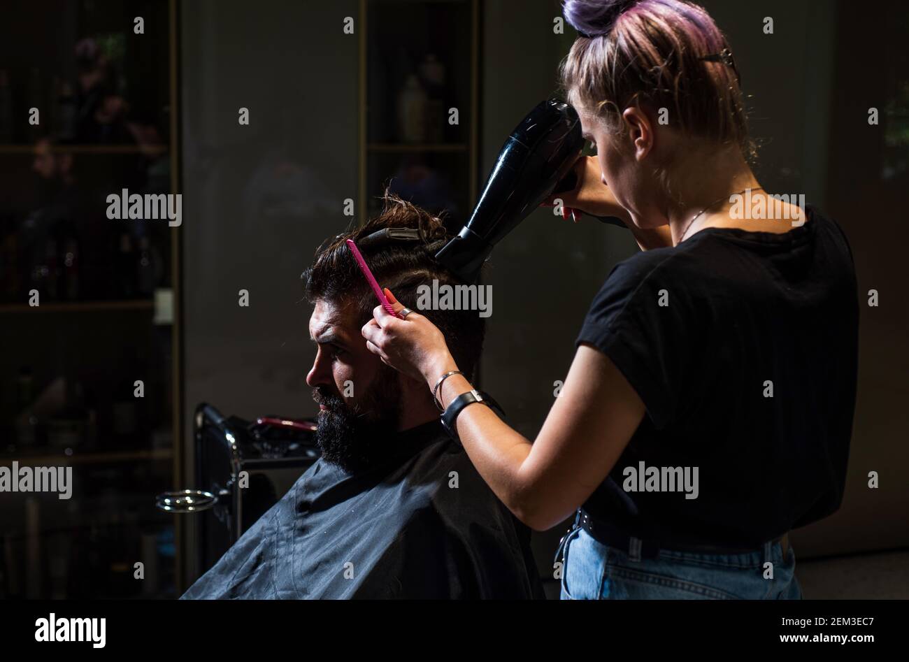 Portrait of stylish male and Barber master with scissors and brush ...
