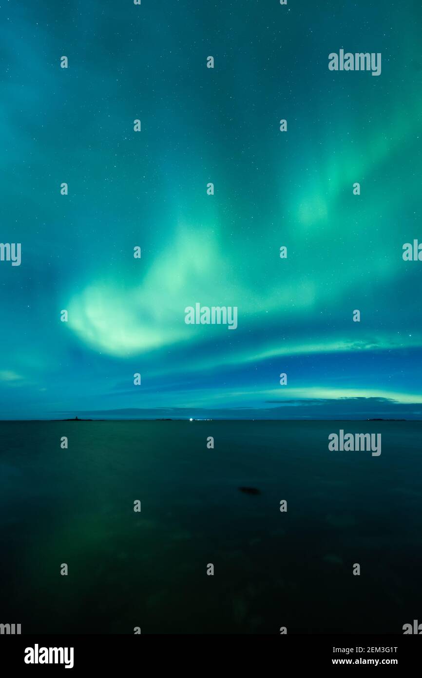 Aurora Borealis on the night sky above the sea. Winter night in Norway ...