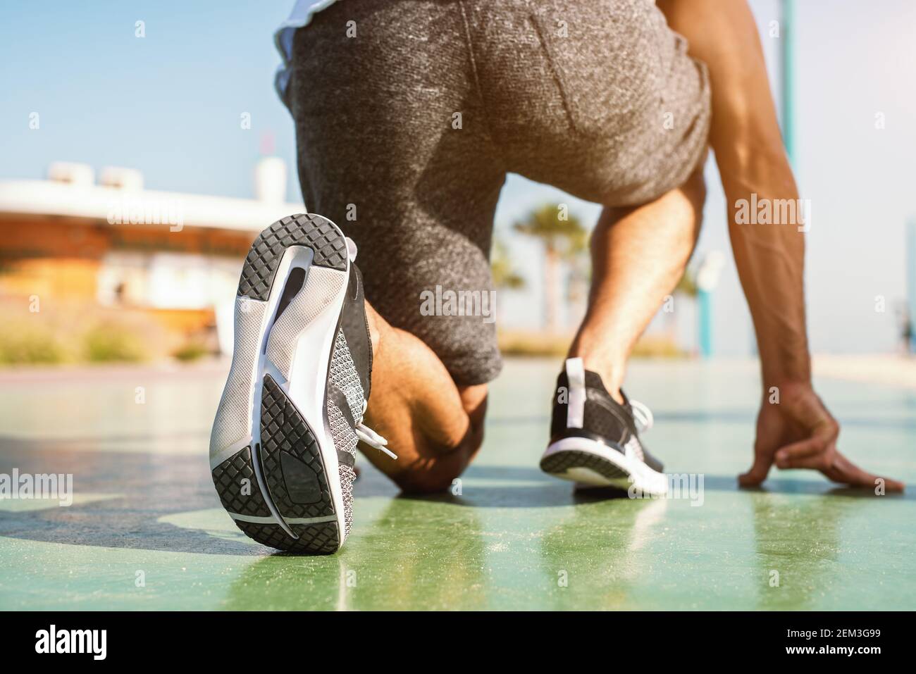 Rare view of a fitness man standing in low start ready to run Stock ...