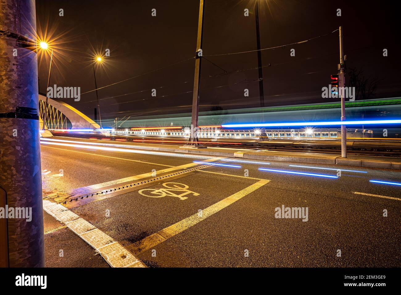 Night traffic in the city with painted cycling mark on the road. Rush ...
