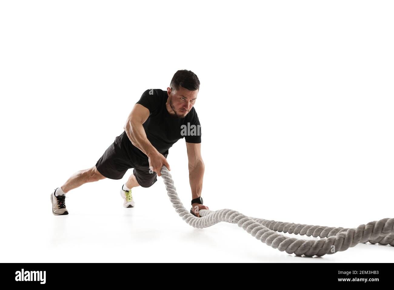 Ropes. Caucasian professional sportsman training isolated on white ...