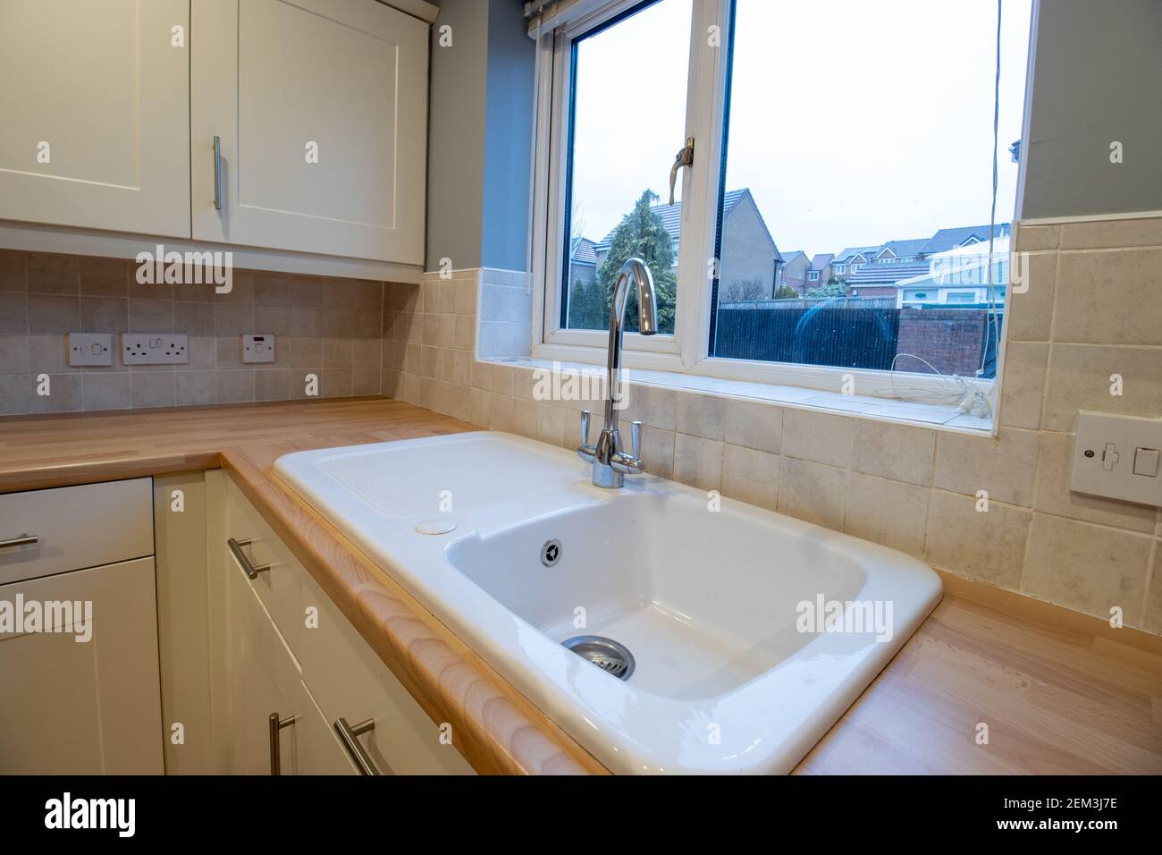 A brand new modern British home showing the Kitchen and sink Stock ...