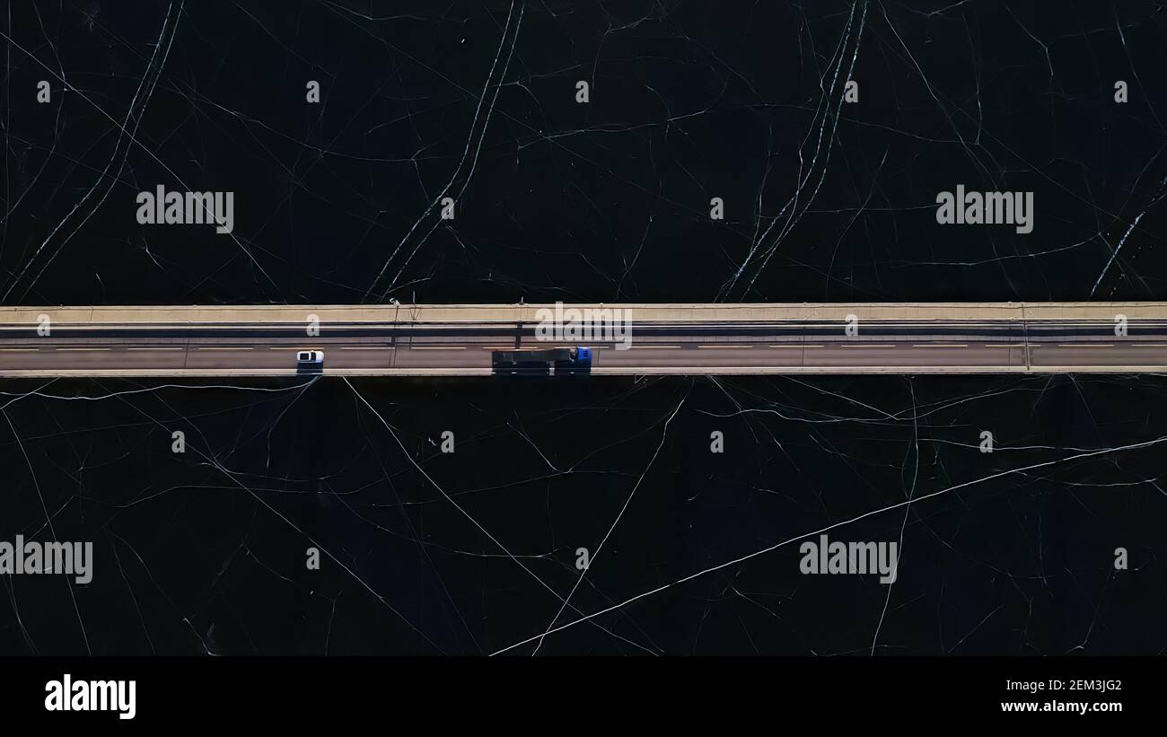 Top down view of a highway bridge spanning over a frozen lake Stock ...