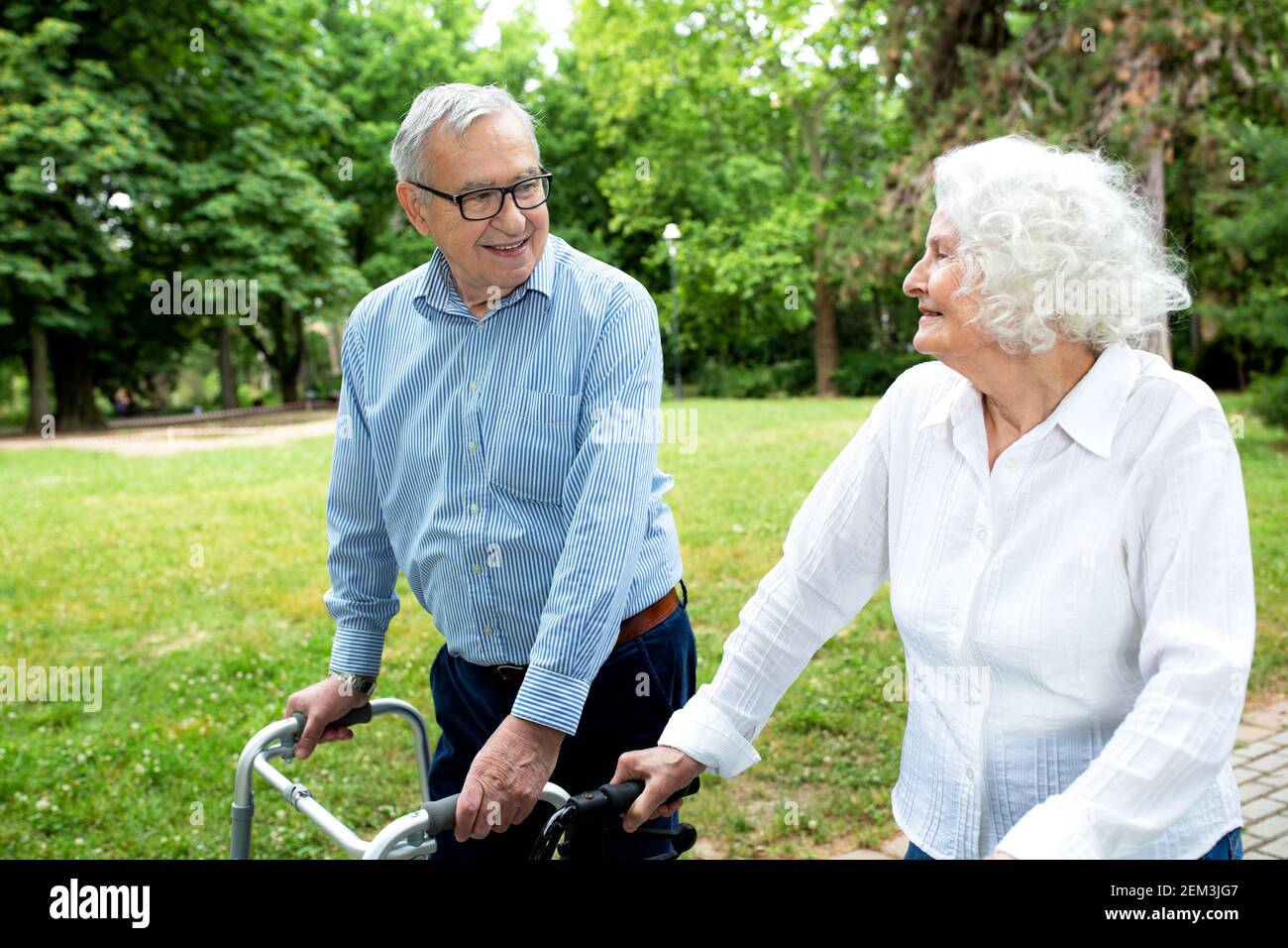 Senior people walking and enjoying a beautiful day in the park using ...