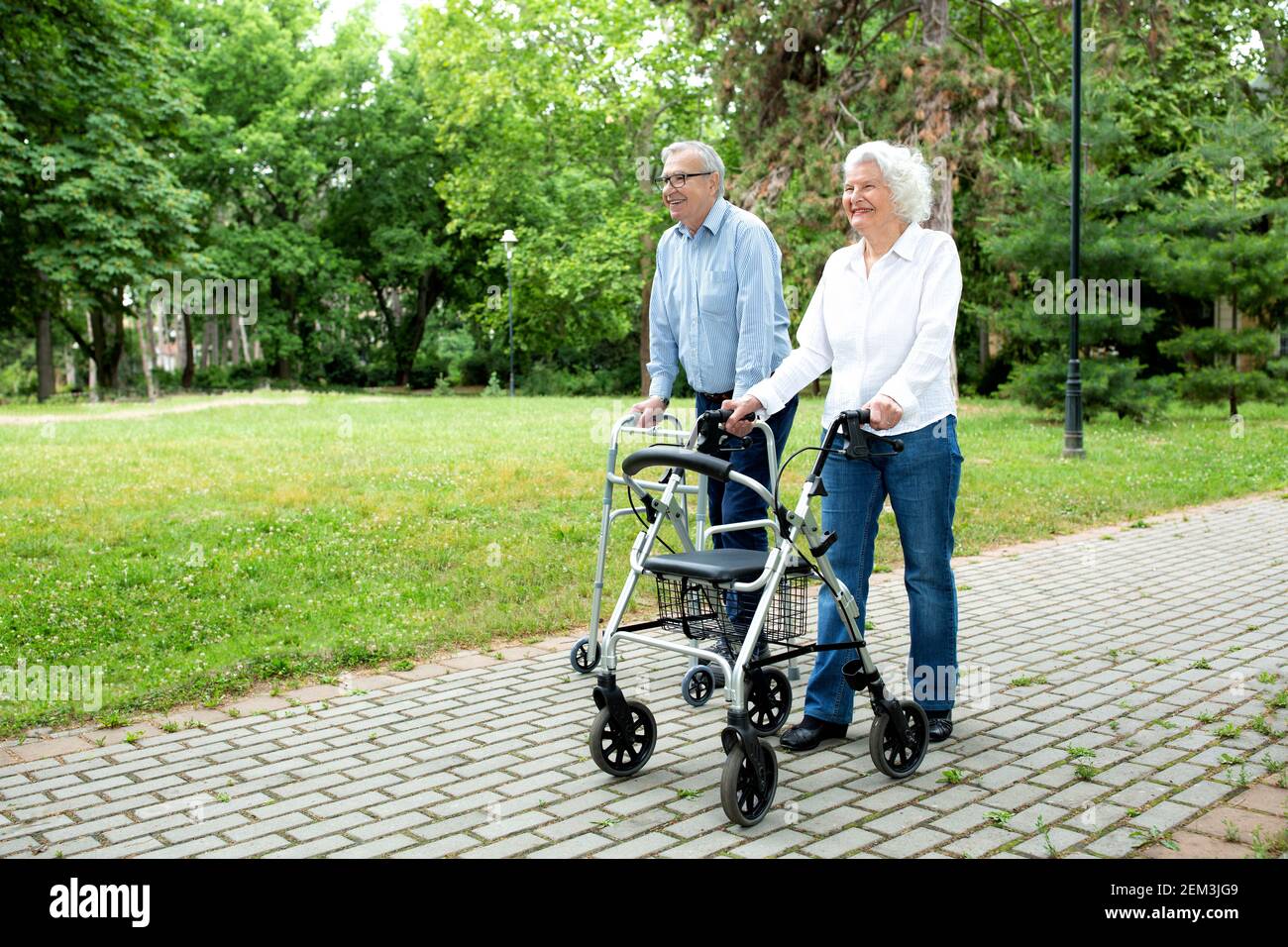 Senior people walking and enjoying a beautiful day in the park using ...