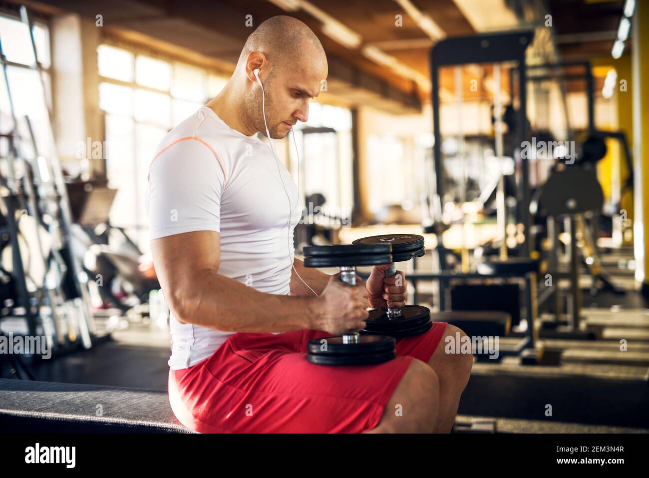Side close up view of strong motivated and focused muscular bald ...