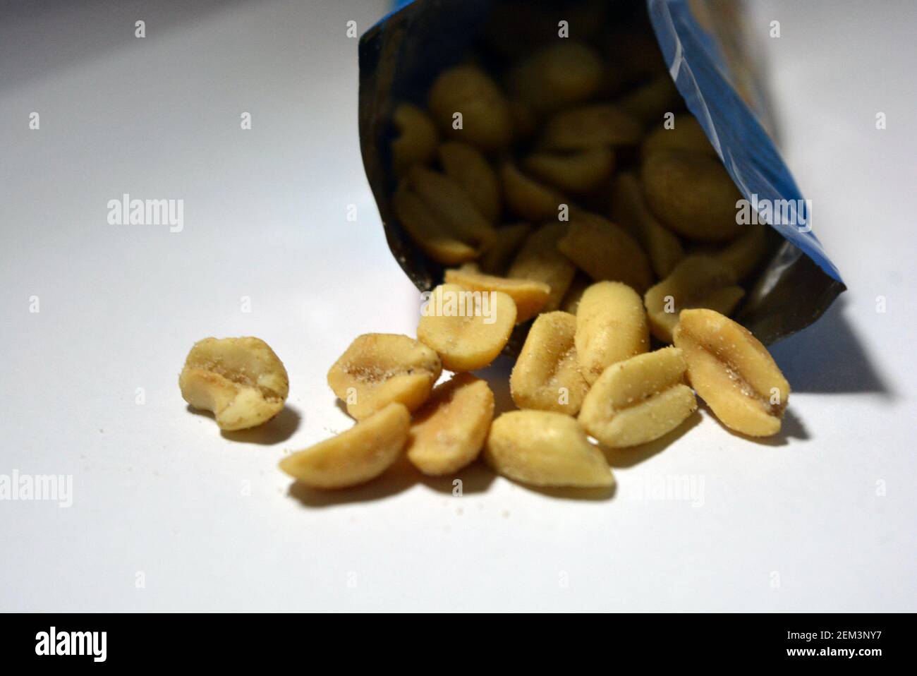 Delicious roasted peeled peanuts with salt laid out on a white plate ...