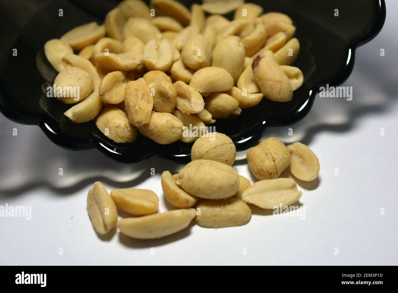 Delicious roasted peeled peanuts with salt laid out on a white plate ...