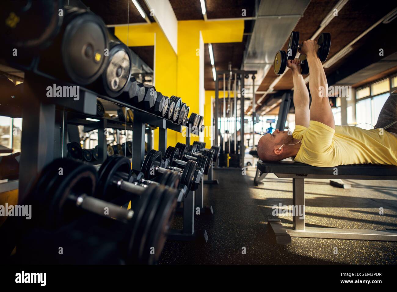 Side view of strong motivated and focused muscular bald bodybuilder man ...