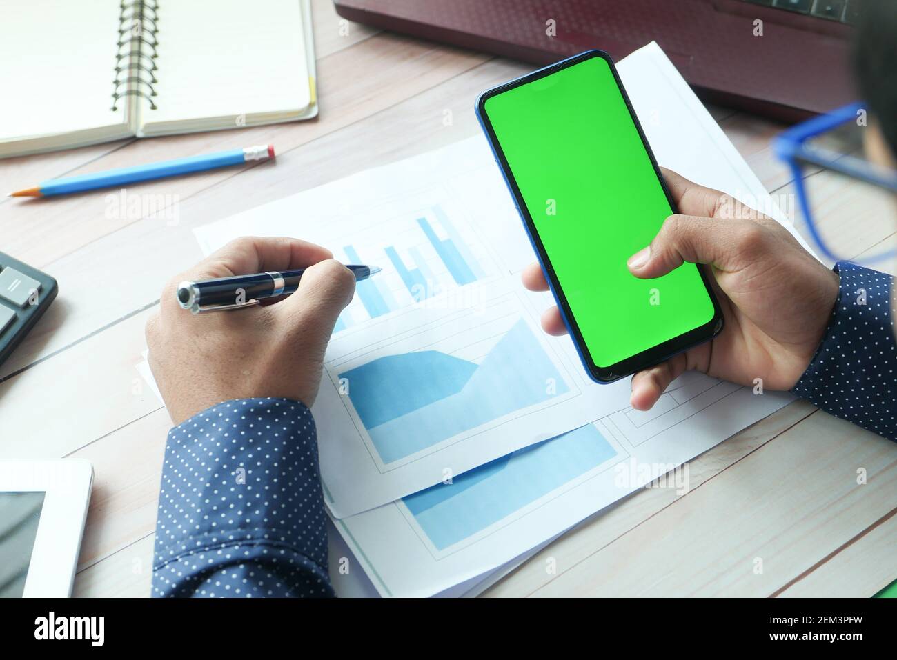 rear view of man hand using smart phone on office desk Stock Photo - Alamy