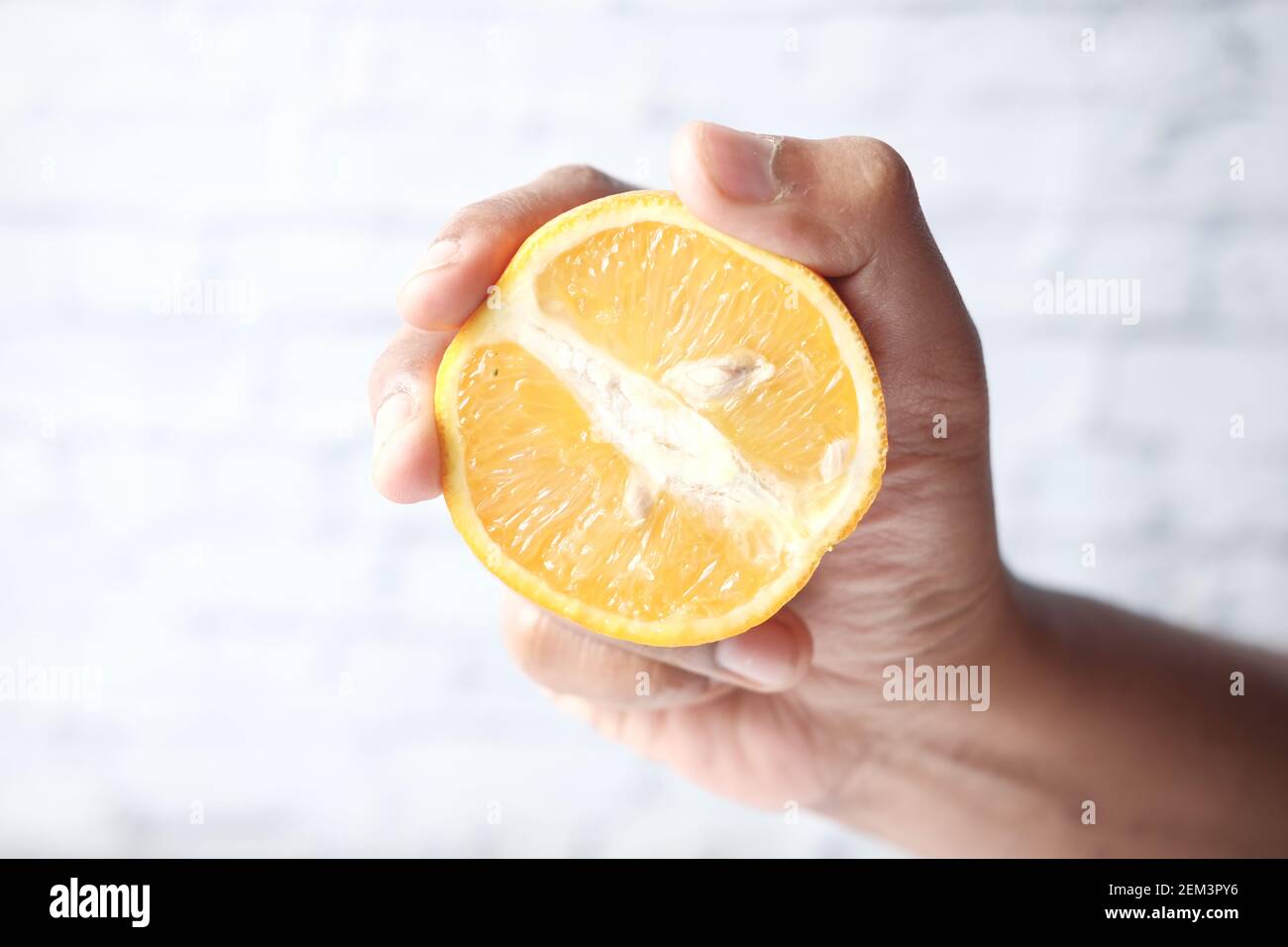 hand holding lemon on white background close up Stock Photo - Alamy