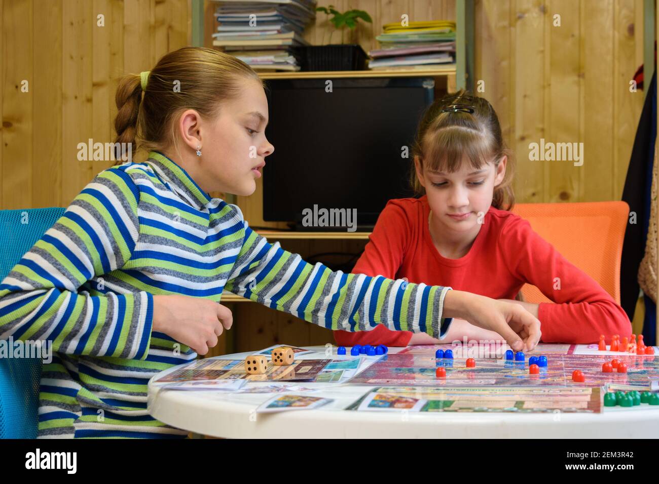 Two girls playing a board game Stock Photo - Alamy