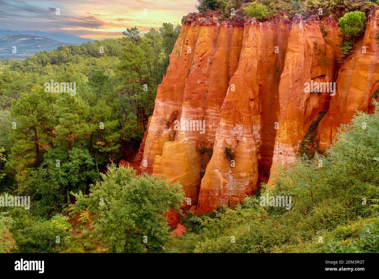 In Roussillon, France, a dramatic cliff of red, orange and yellow ochre ...