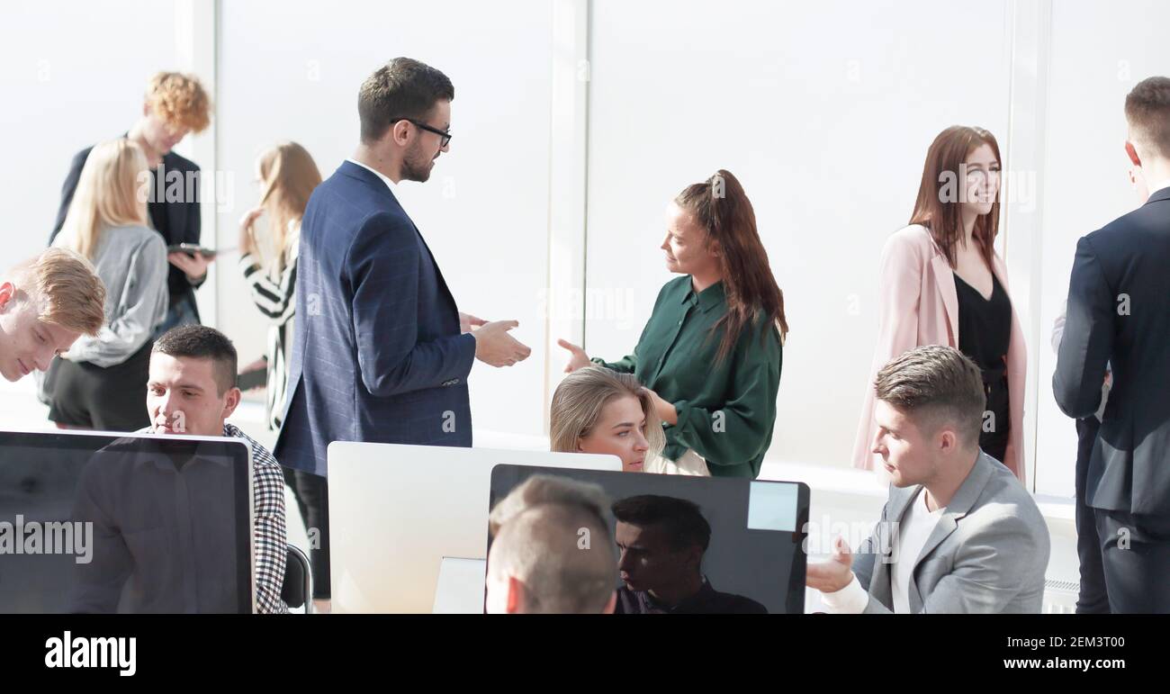employees of the company work in a modern large office Stock Photo - Alamy