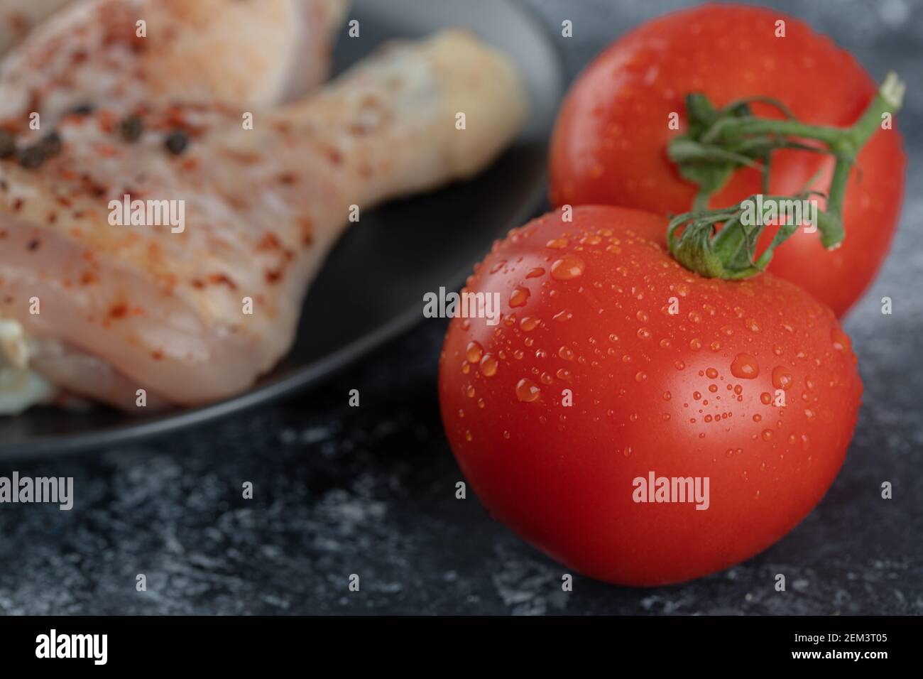 Macro photo of tomatoes and chicken legs Stock Photo - Alamy