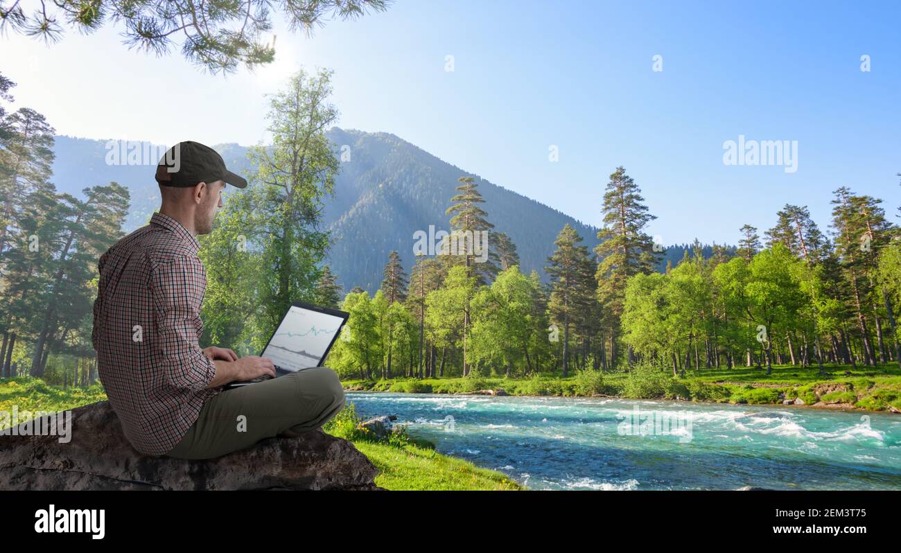 man working remotely outdoors with laptop Stock Photo - Alamy