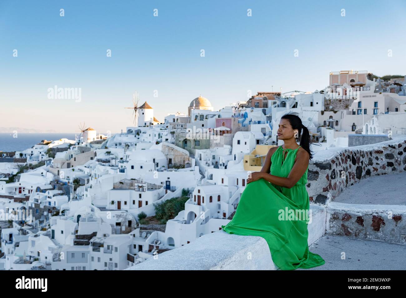 Oia village Santorini with blue domes and white washed house during sunset at the Island of ...