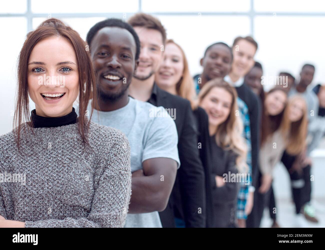 close-up . young woman standing in front of a group of young people ...