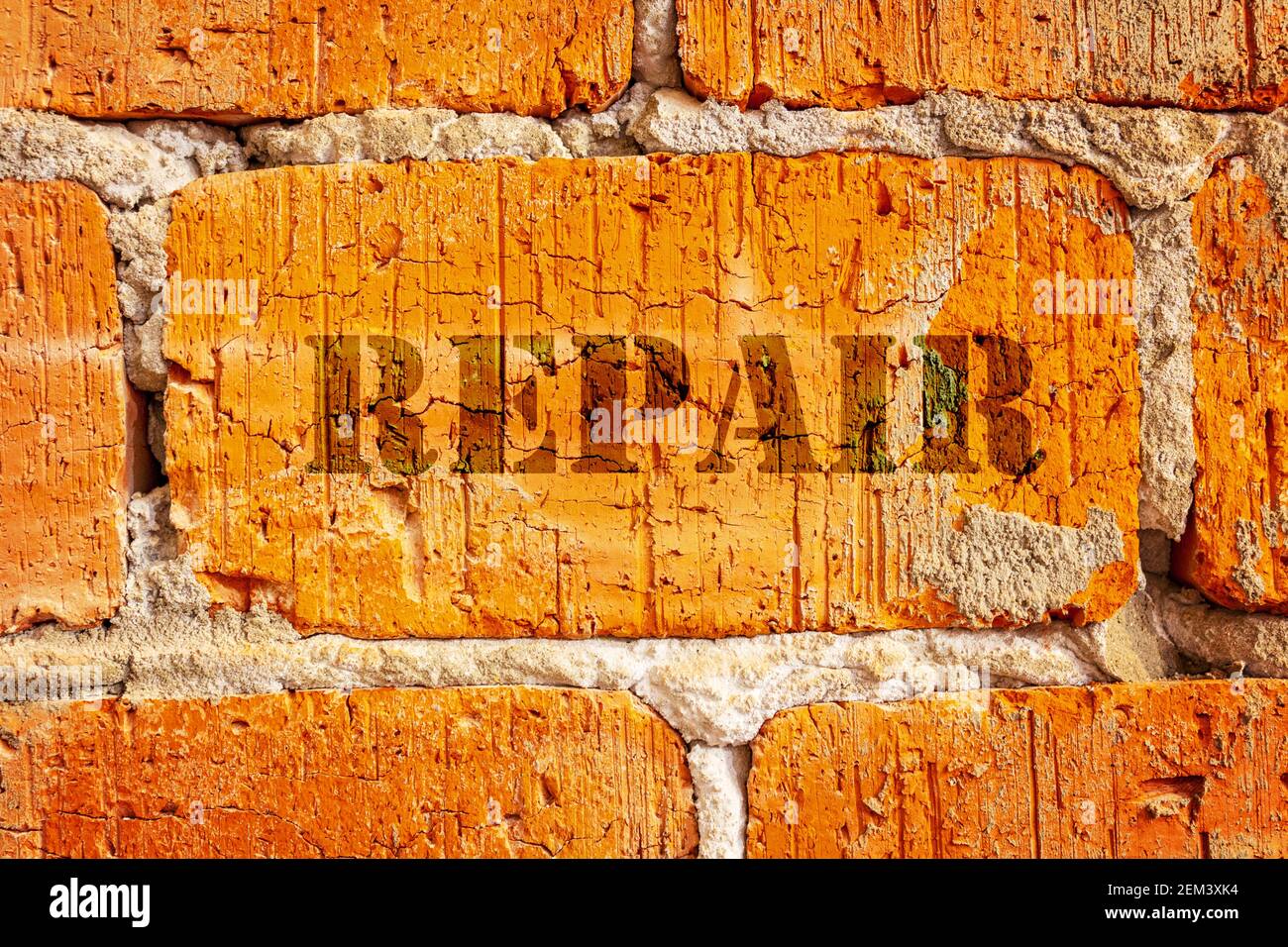 Textured background of old cracked red bricks with the inscription ...