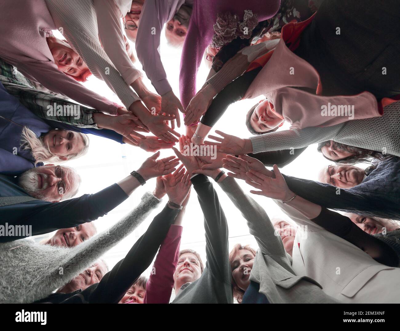 Creative business team stacking hands together in office Stock Photo ...