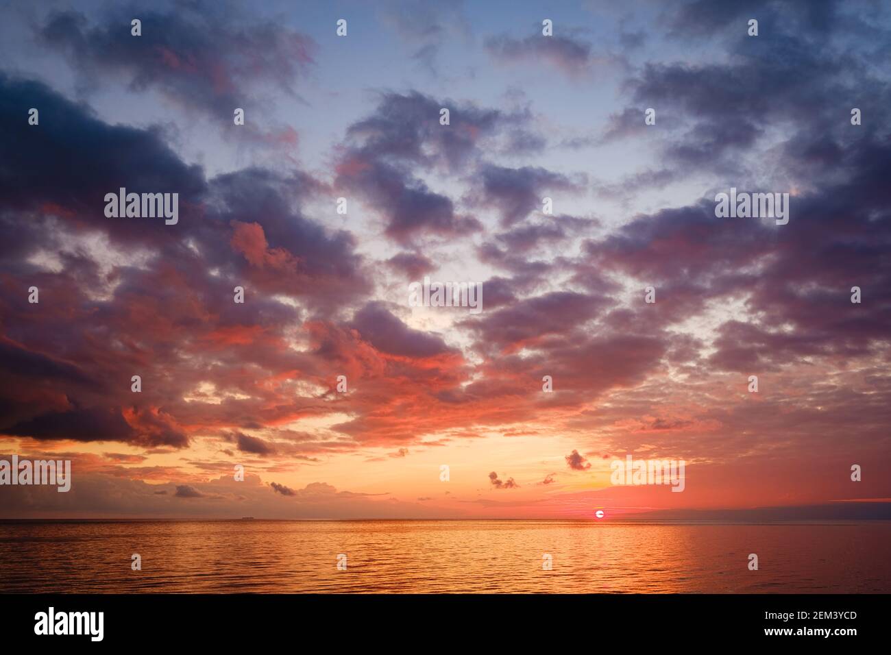 Calm sea with sunset sky and sun through the clouds over. Meditation ...