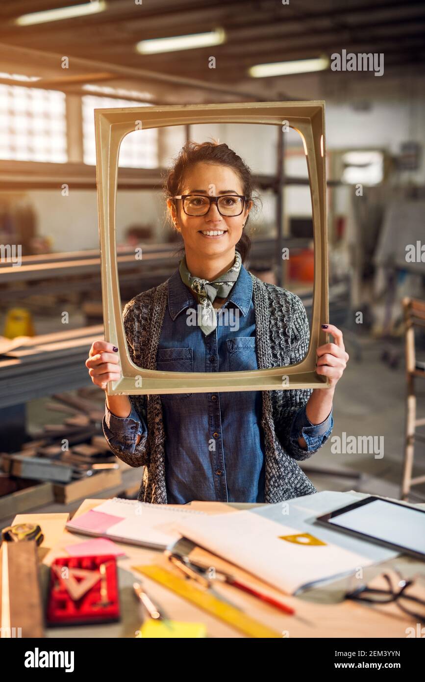 Close up vertical view of cheerful happy middle aged engineer holding ...