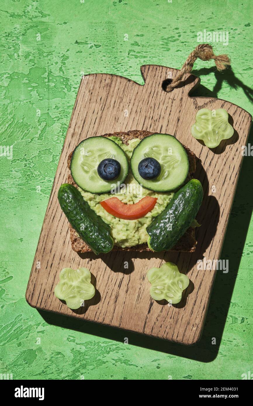 Funny Frog Toast With Cucumber And Mashed Avocado Stock Photo - Alamy