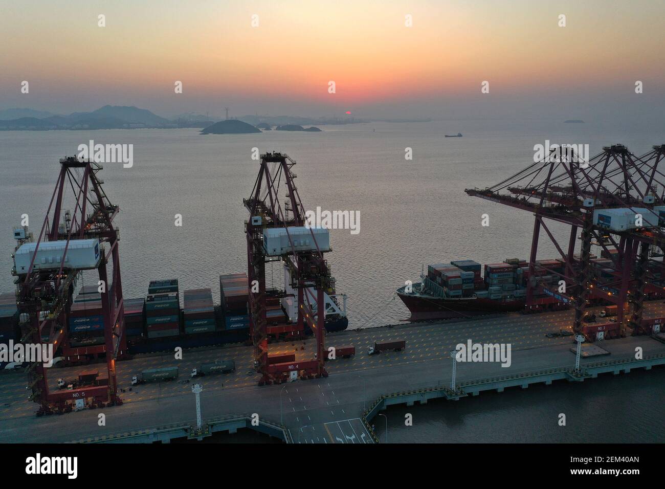 Two feeder ships and a barge feeder ship are busy with loading and ...