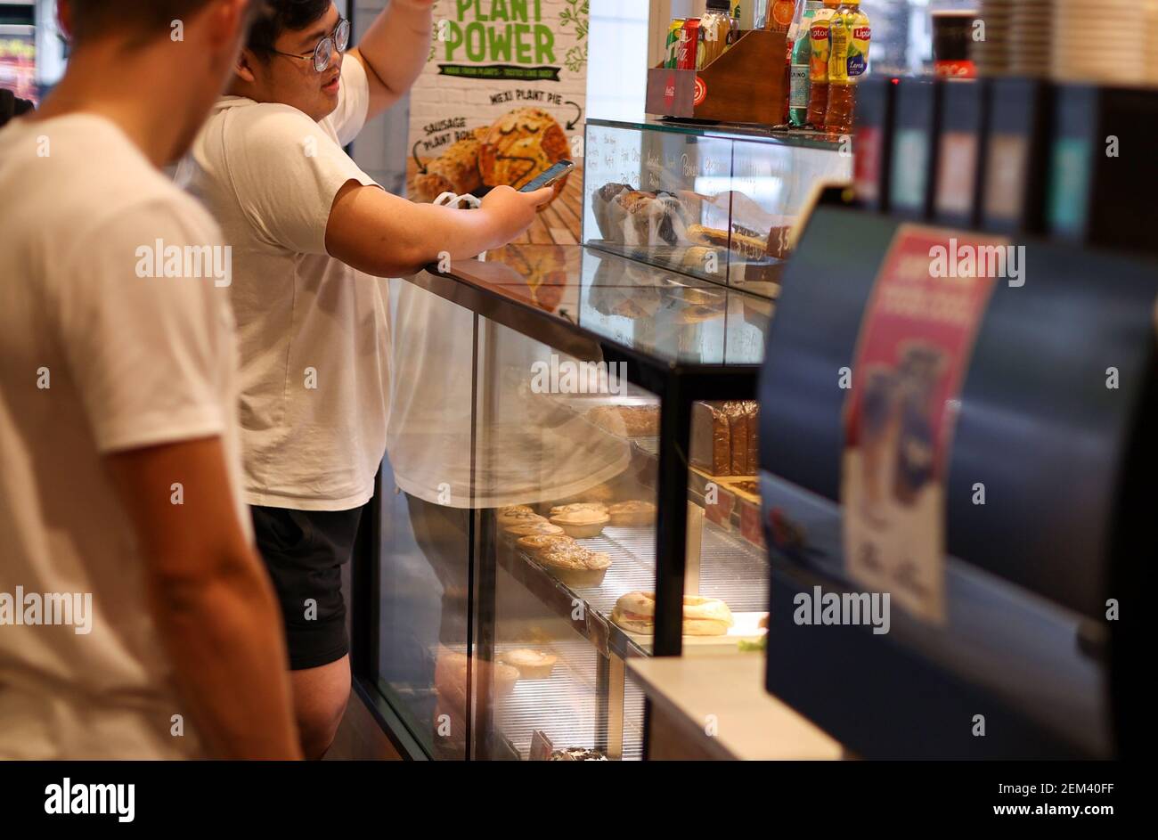 Sydney, Australia. 24th Feb, 2021. People buy meat pies at a meat pie ...