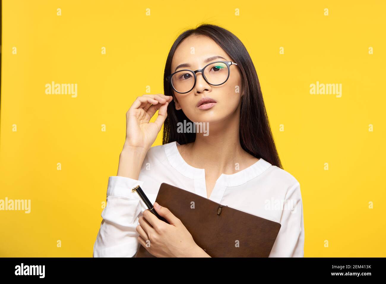 woman holding notepad secretary office yellow background Stock Photo ...