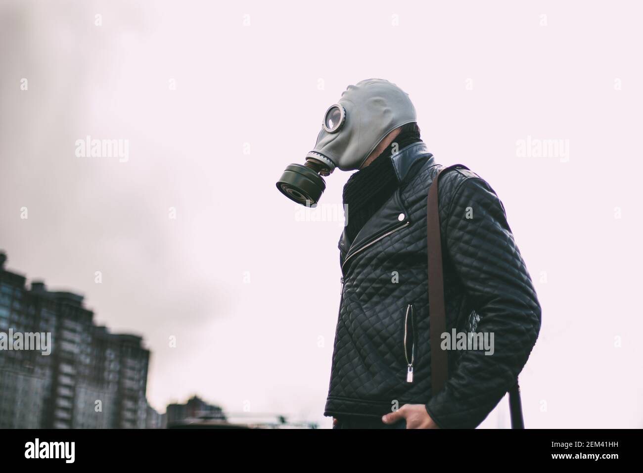 man in a gas mask walking through a city Parking lot Stock Photo - Alamy