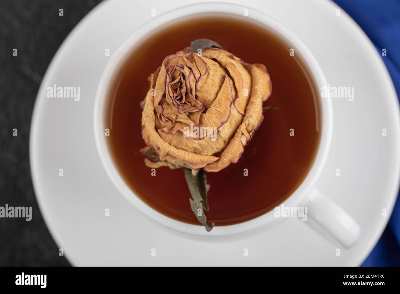 A cup of tea with dried flowers on a black background Stock Photo - Alamy