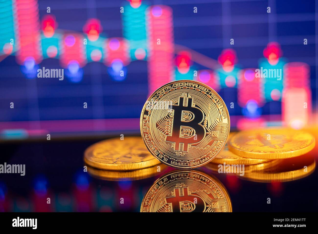 Gold Bitcoin crypto currency on background of red candles chart diagram ...