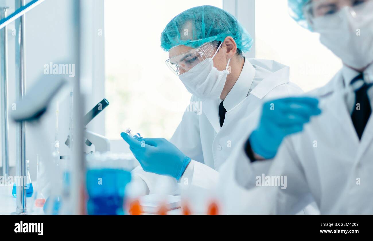 close up. group of scientists sitting at a laboratory table Stock Photo ...