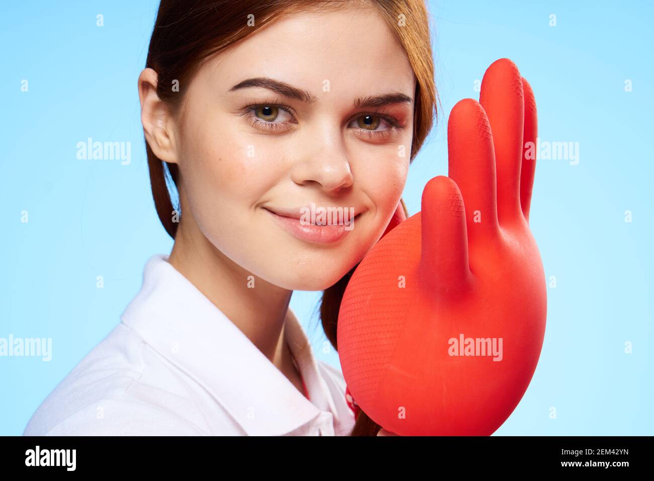 cheerful pretty woman with inflated glove near face service ...