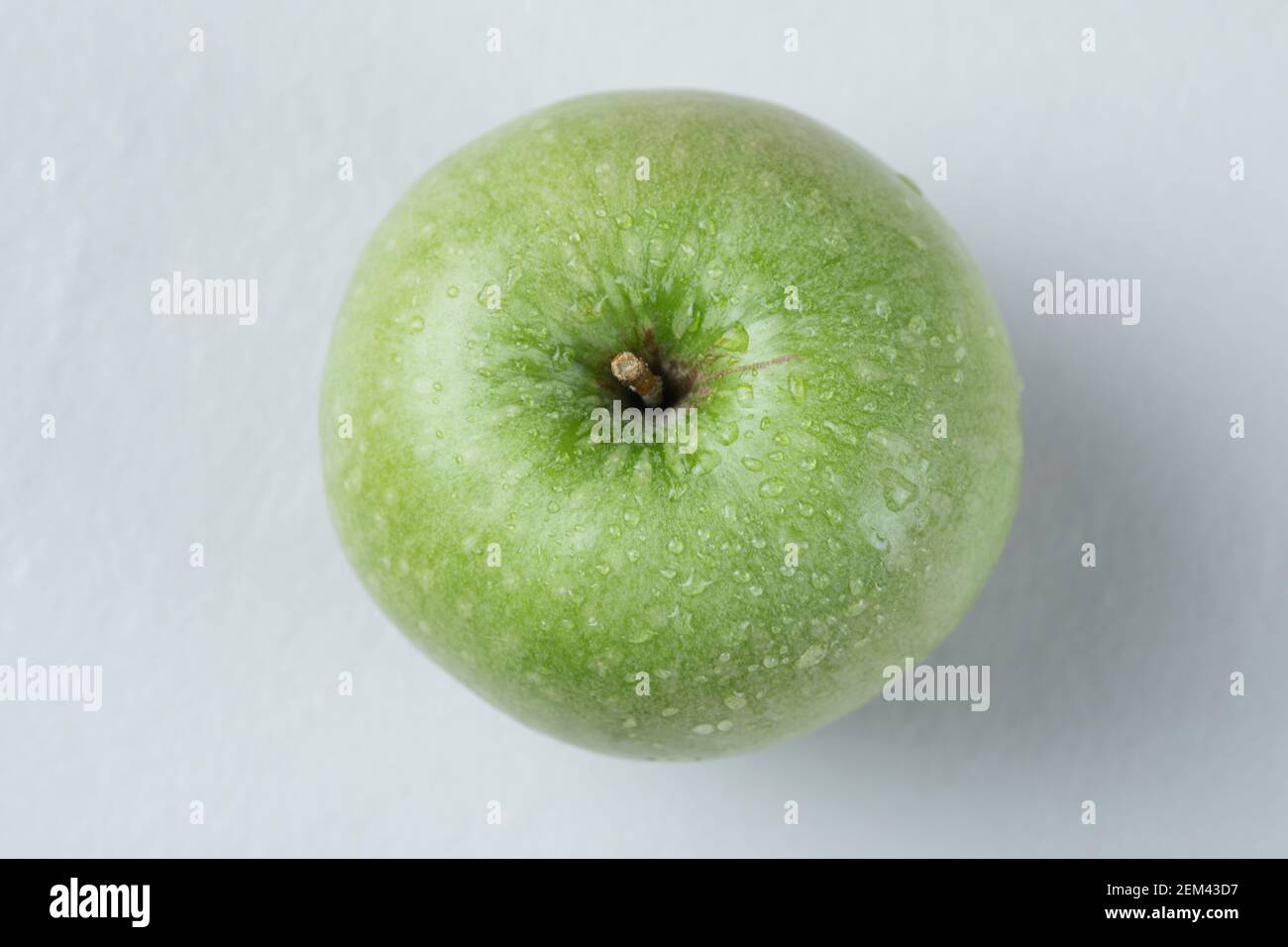 A single green apple isolated on the grey background Stock Photo - Alamy