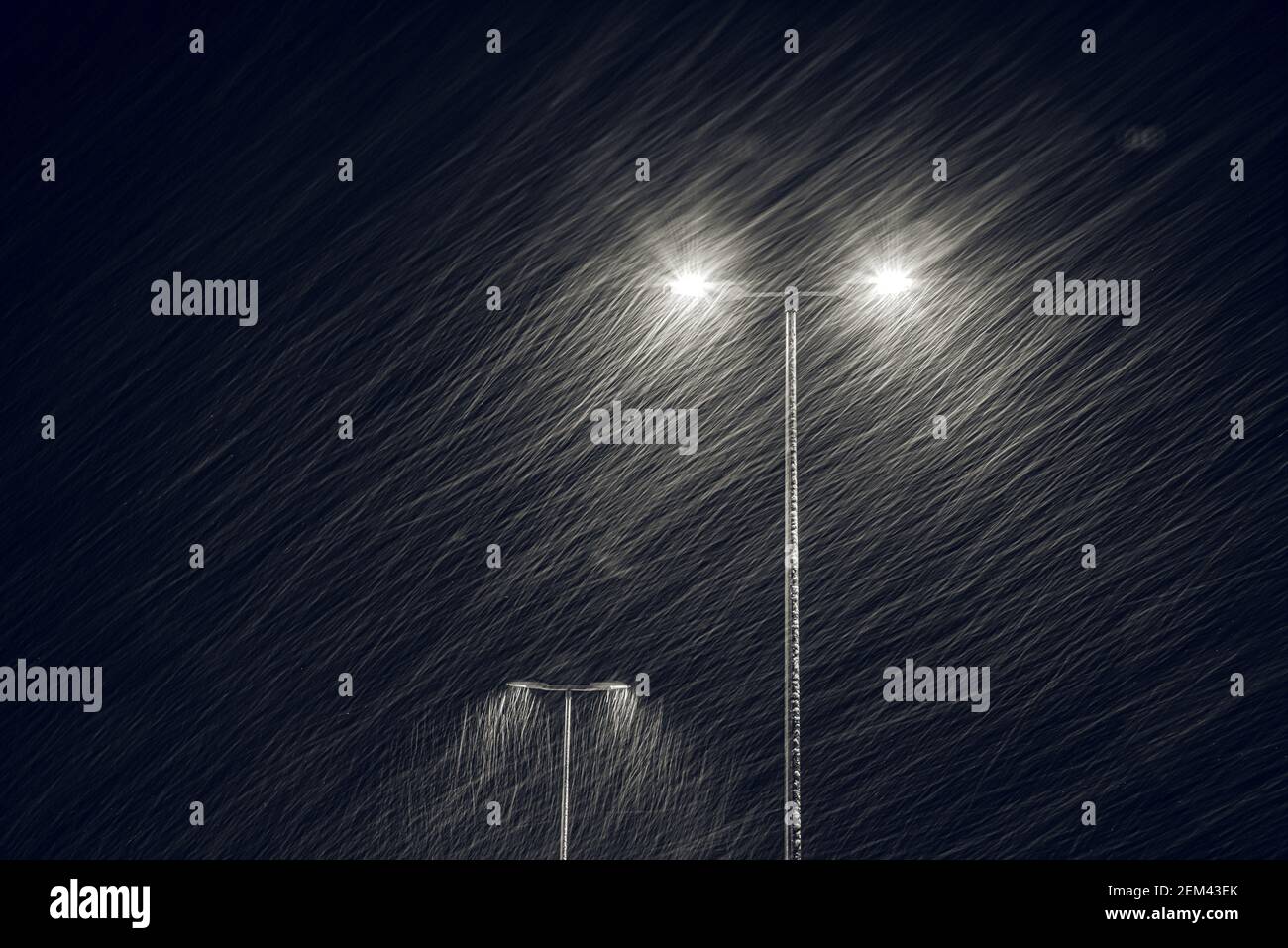 Snow falling at night on the background of a burning street lamp Stock ...