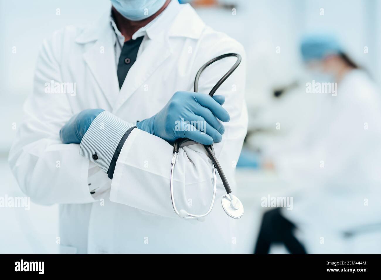 practicing doctor with a stethoscope in his hands on the background of ...