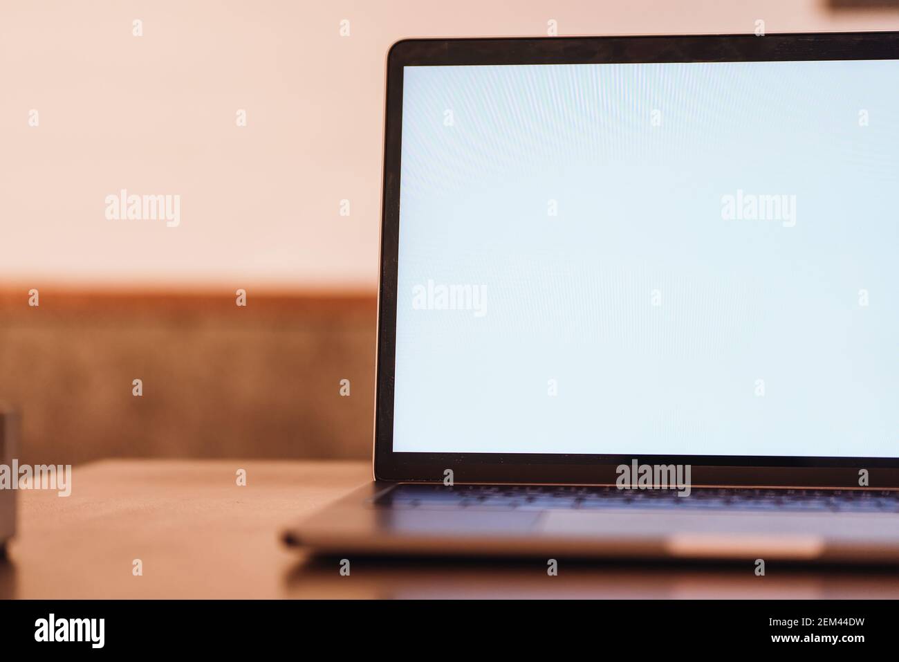 Conceptual workspace, Laptop computer with blank white screen on table ...