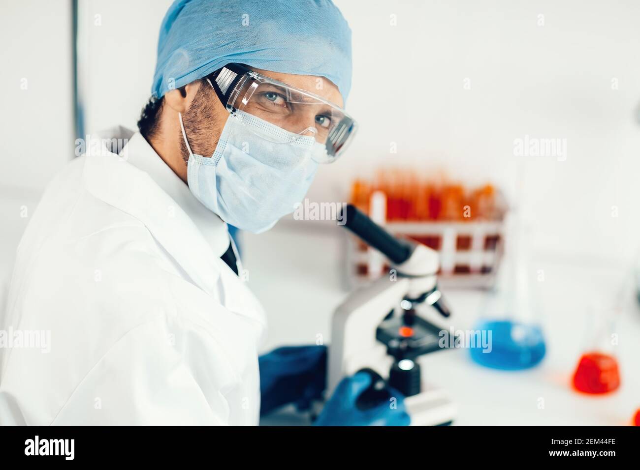 scientist looking at a drop of blood through a microscope Stock Photo ...