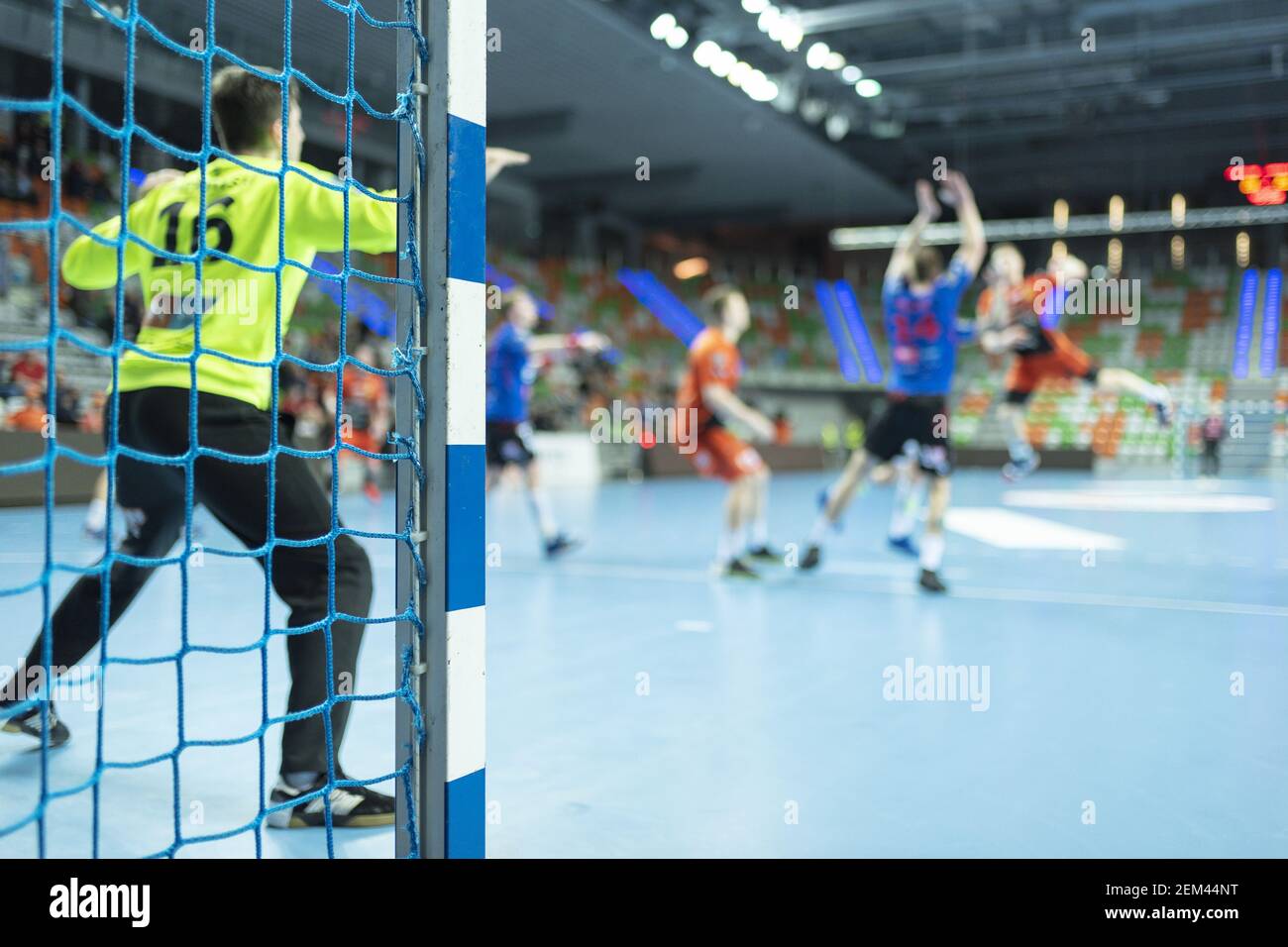 Detail of handball goal post with net and handball match in the ...