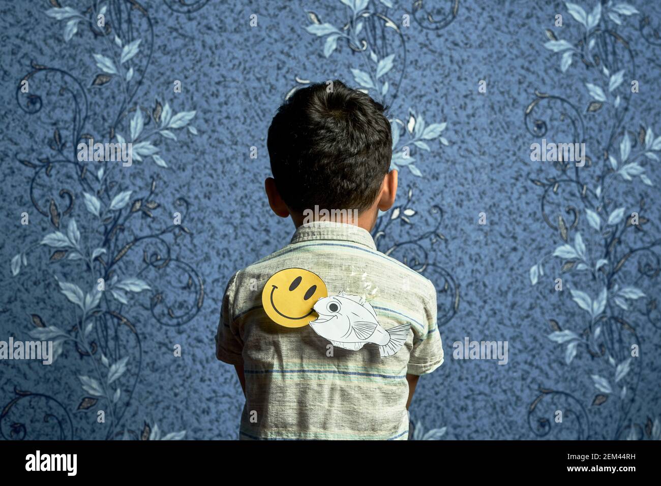 April fools day jokes. A smile and fish stickers on the boy back. 1 ...