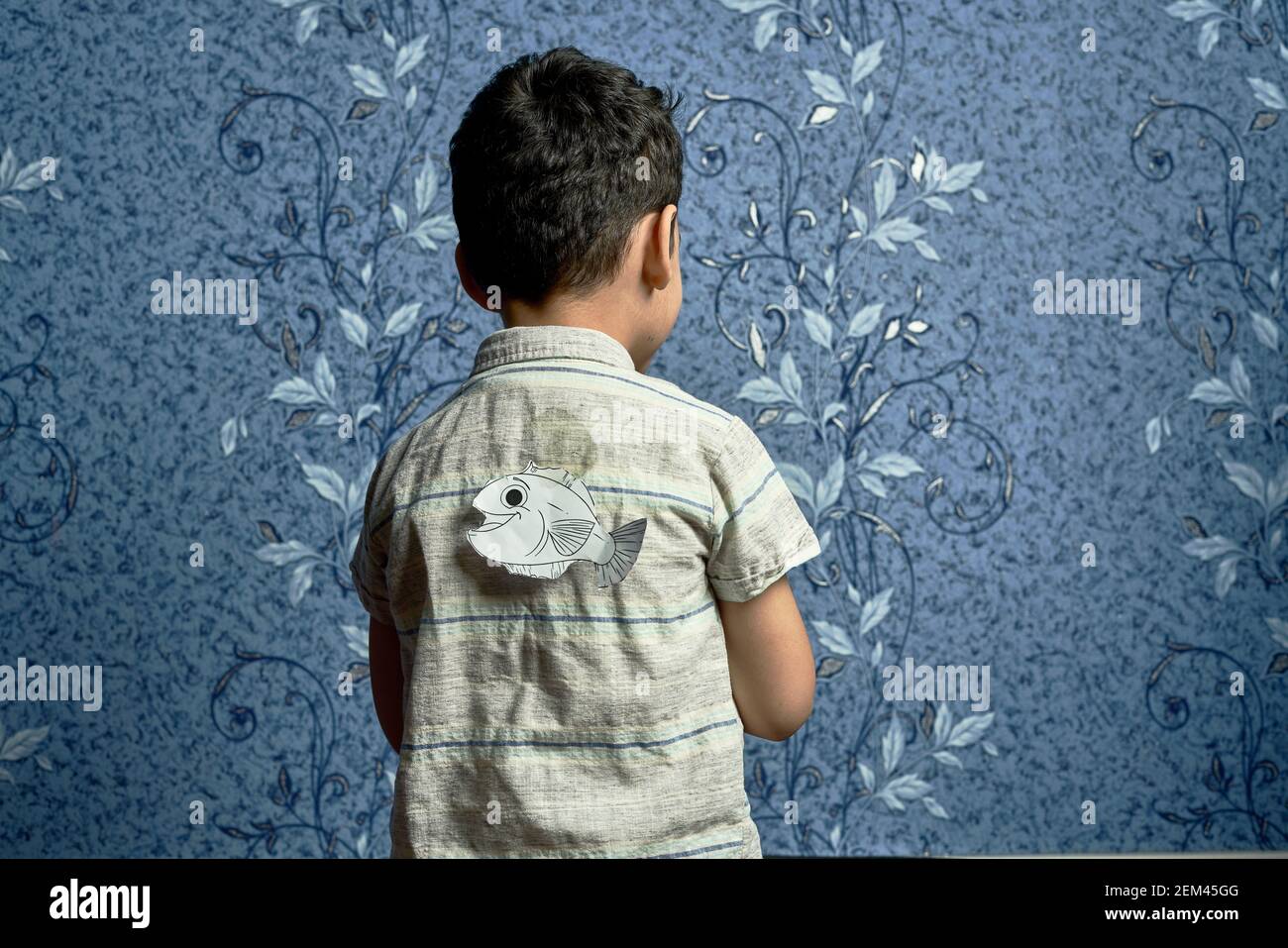 April fools day jokes. A fish stickers on the boy back. 1 April fools ...