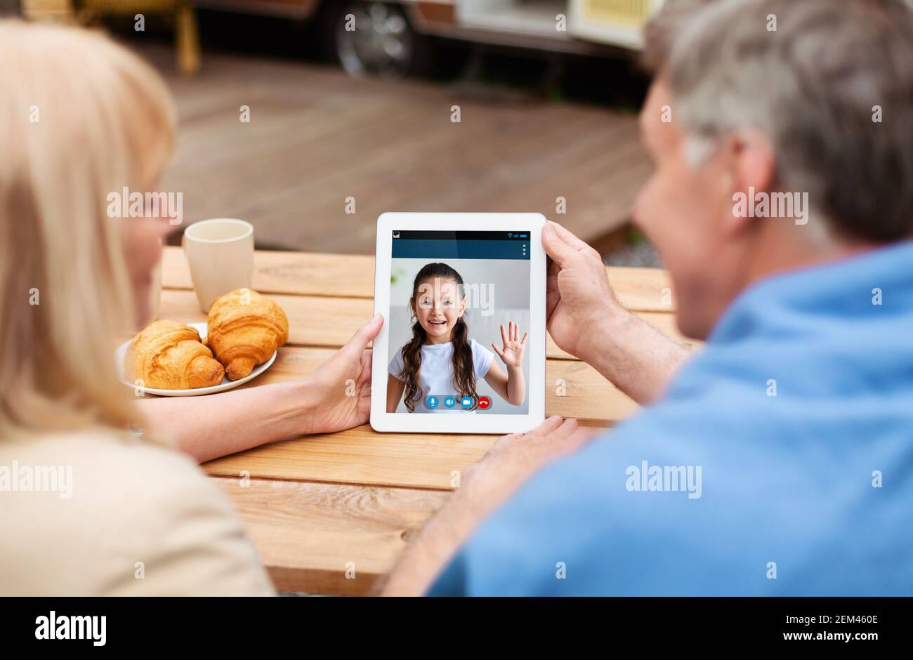 Grandparents making video call with kid using tablet Stock Photo - Alamy