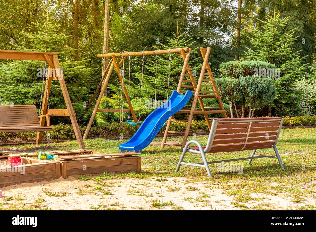 Empty modern wooden children playground set on green yard in public ...