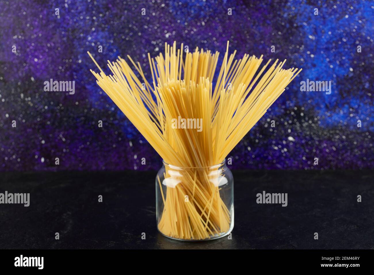 Raw dry spaghetti in a glass jar on a bright background Stock Photo - Alamy