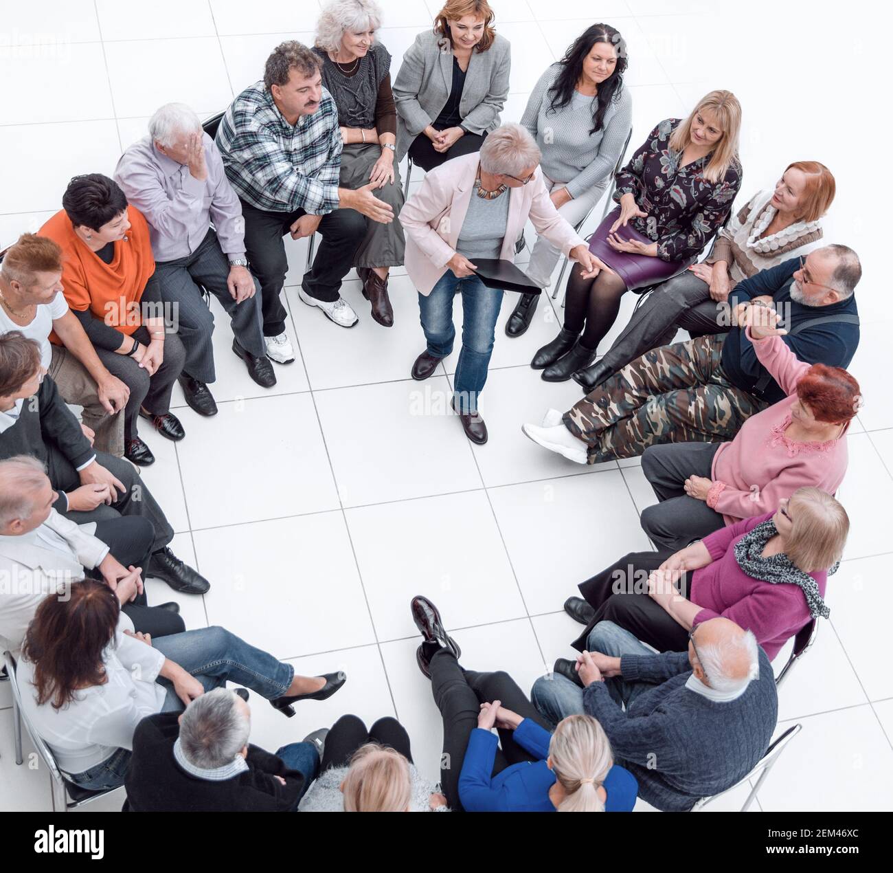confident older woman standing in a circle of like-minded people Stock ...
