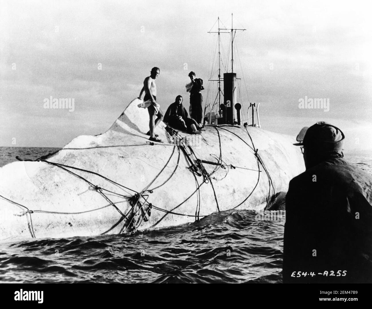 JOHN HUSTON on set candid directs GREGORY PECK on the Great White Whale model during filming in ...