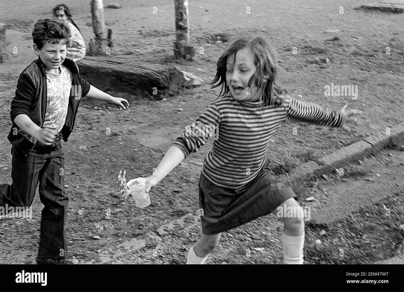 Childrens Adventure Playground Boy chasing Girl with water Stock Photo ...